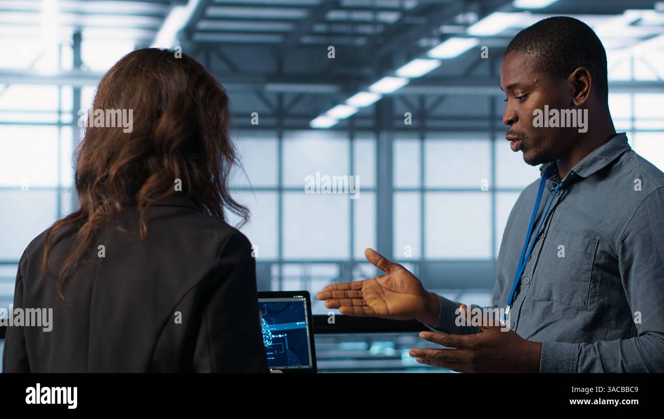 Team of engineers in data center with tablet integrating AI driven automation tools, doing ...