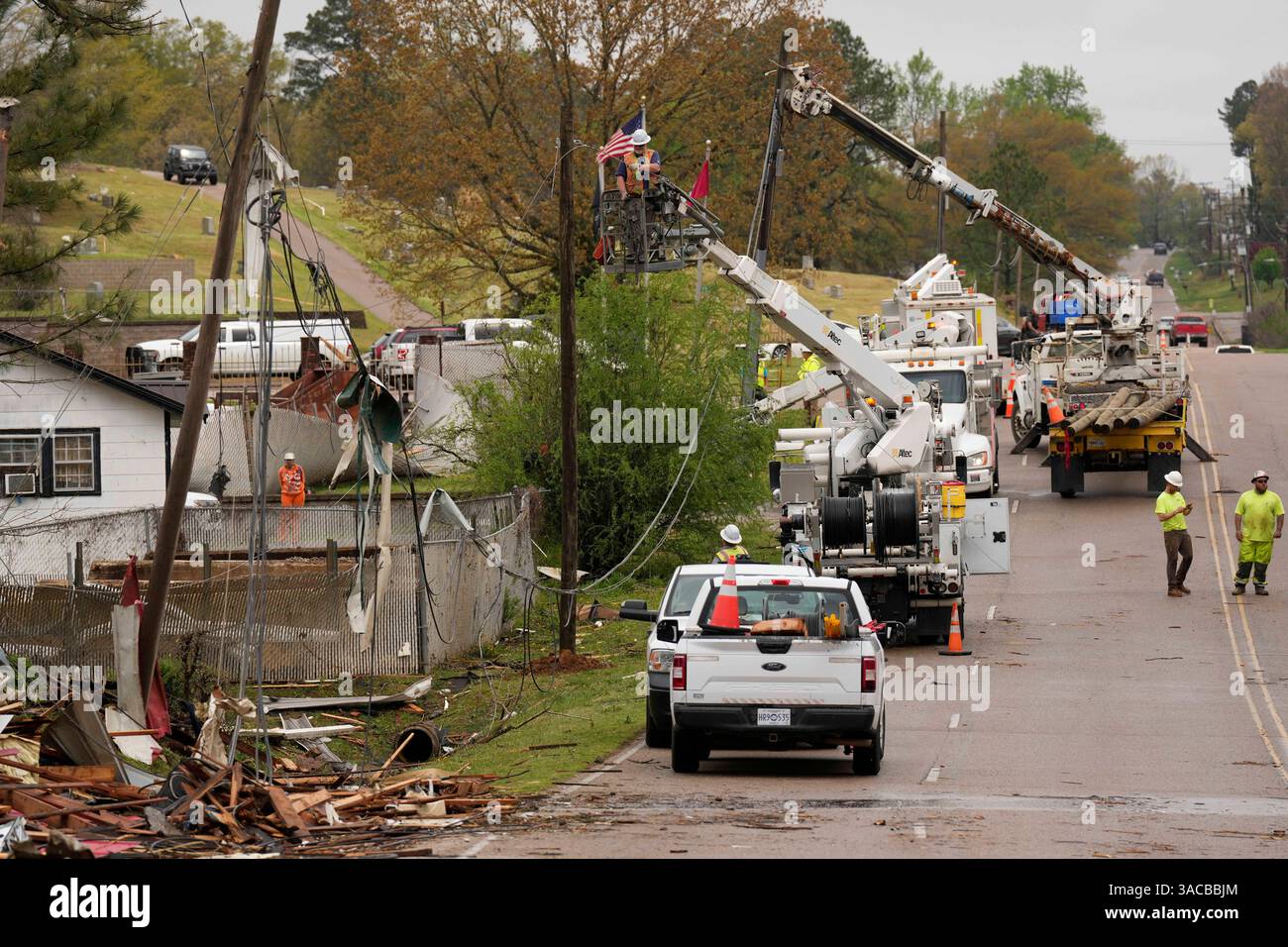 Utility workers tend to damaged power lines following severe weather in ...