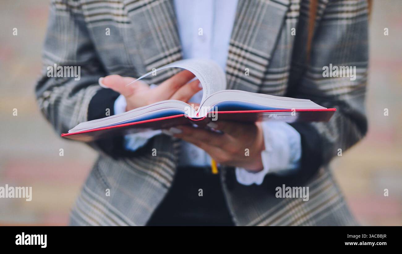 Student reading book while sitting on park bench, absorbing knowledge ...