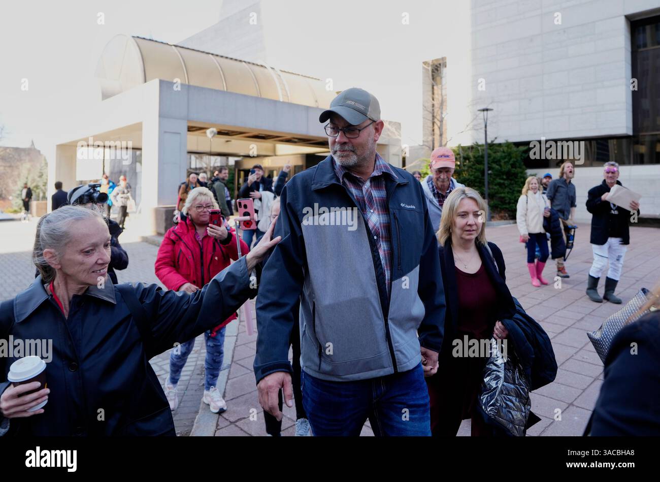 A supporter greets Chris Barber as he leaves the courthouse in Ottawa ...
