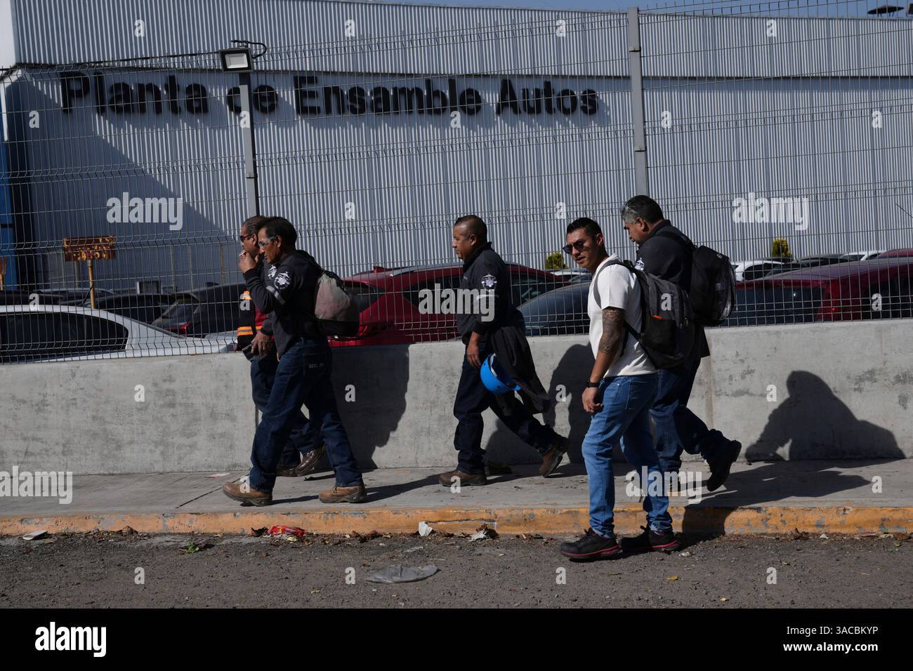 Workers arrive at the Stellantis car assembly plant in Toluca, Mexico ...