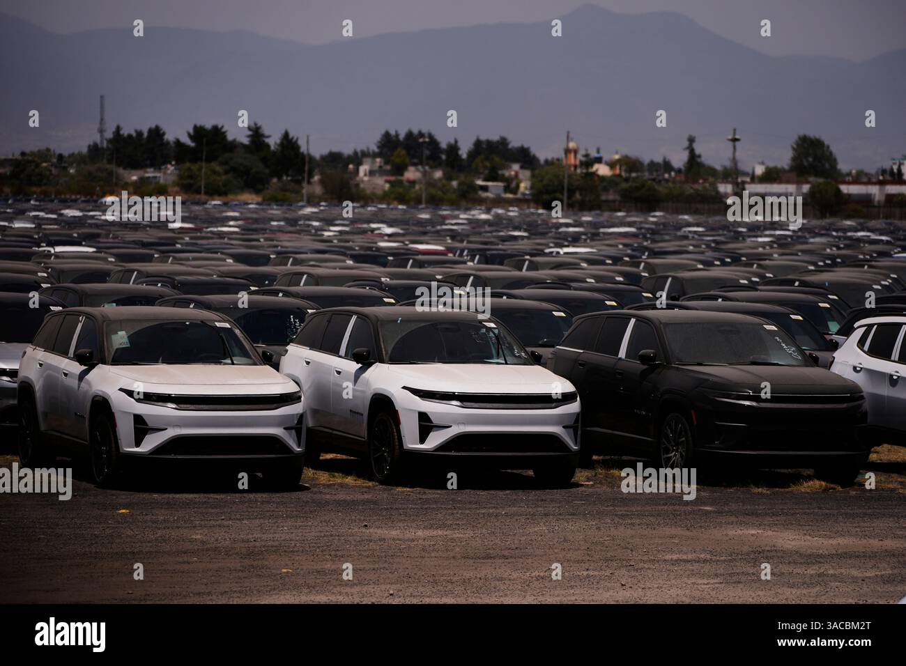 Cars are parked outside the Stellantis car assembly plant in Toluca ...