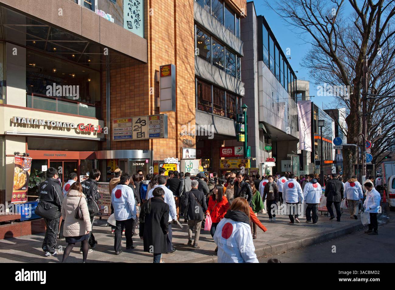 Sidewalk maintenance cleaning crew with red dot (hinomaru) on back ...