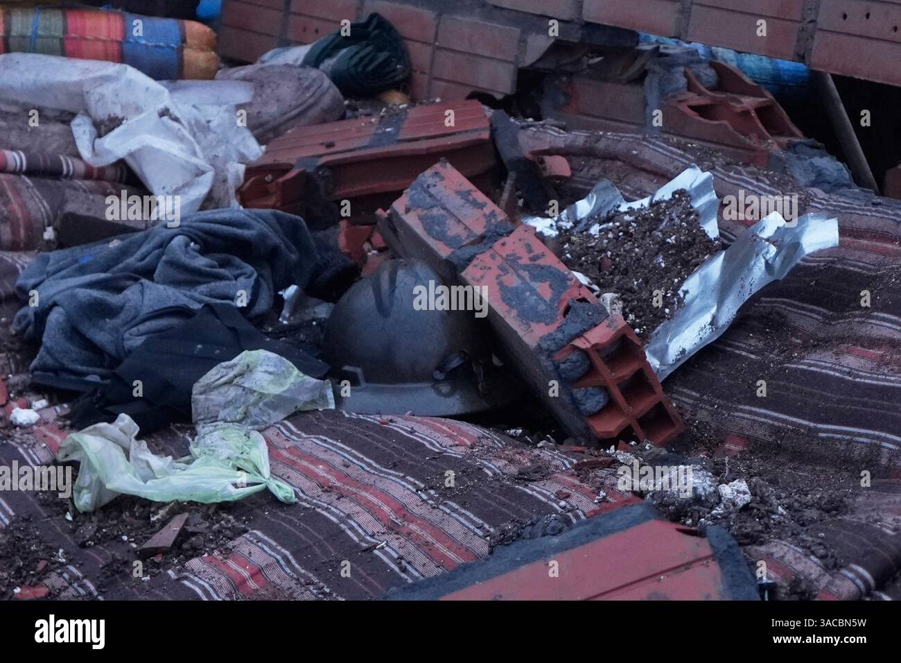 A miner's helmets sits near debris following an explosive attack near ...