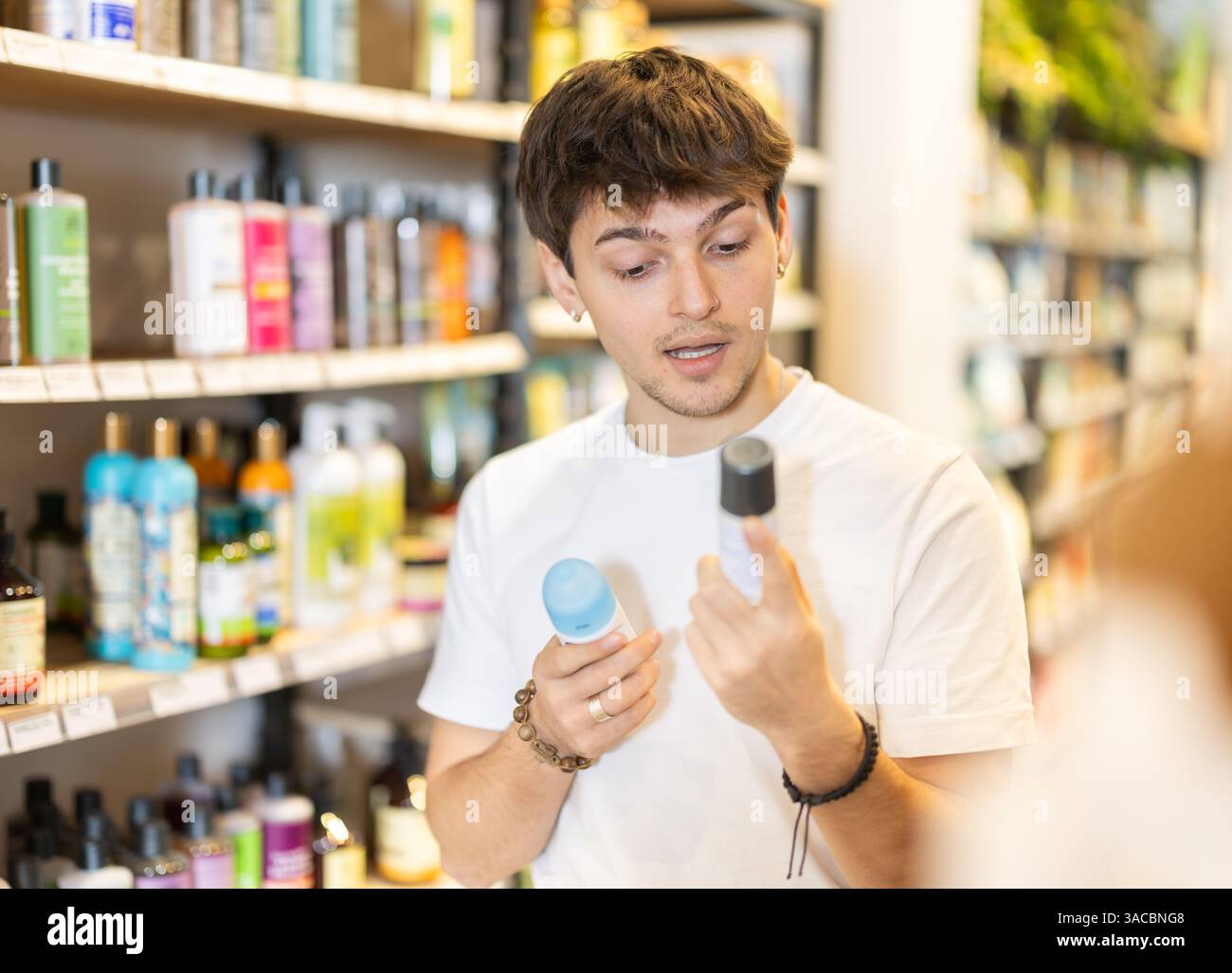Guy chooses deodorant Stock Photo - Alamy