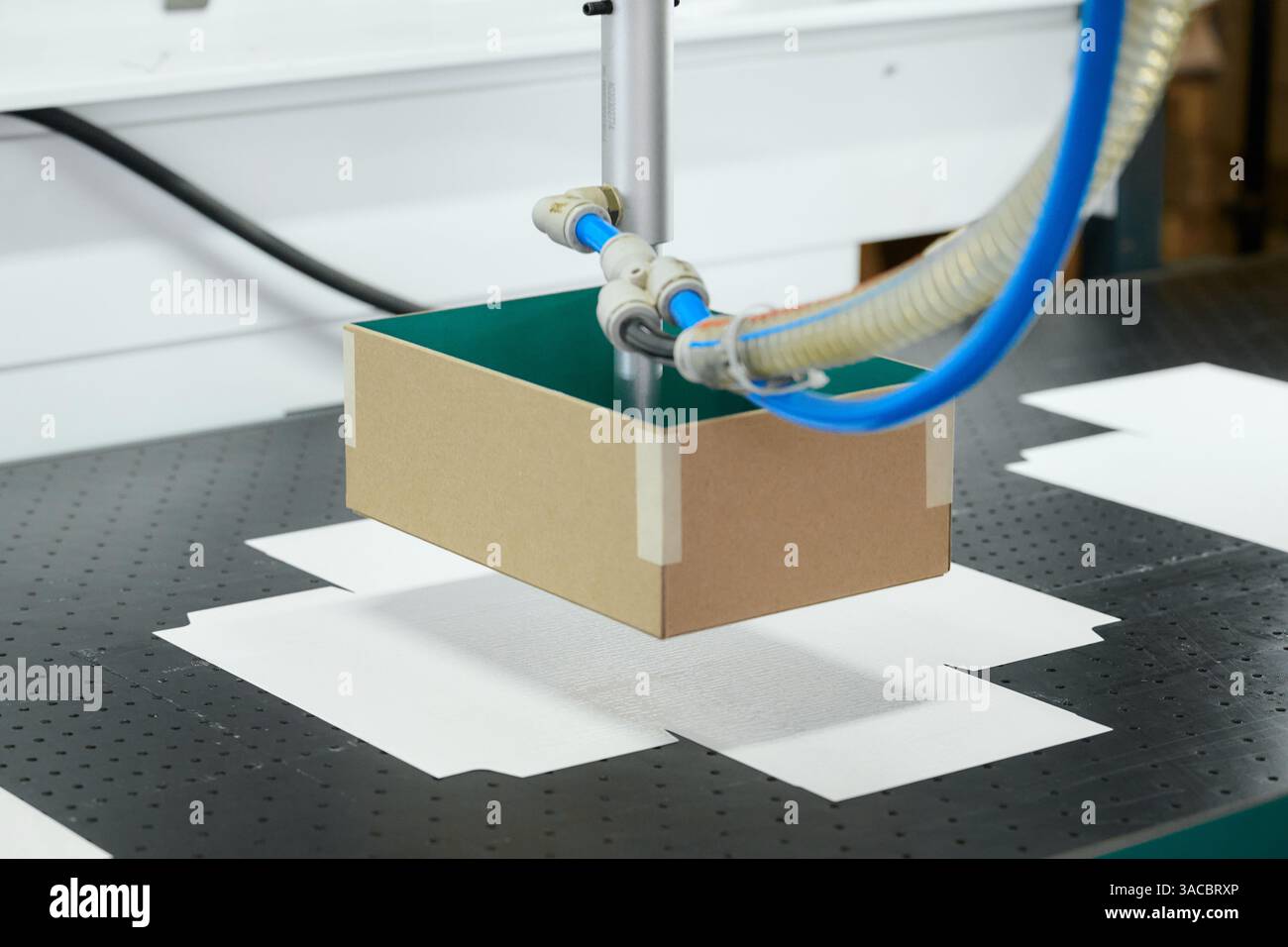 Innovative robot technology streamlines cardboard box gluing process in ...