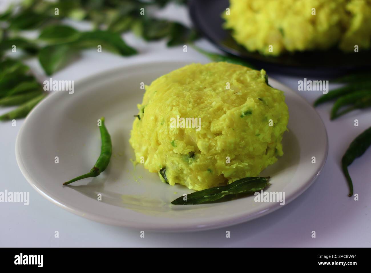 Boiled and mashed tapioca, blended with turmeric and garnished with ...