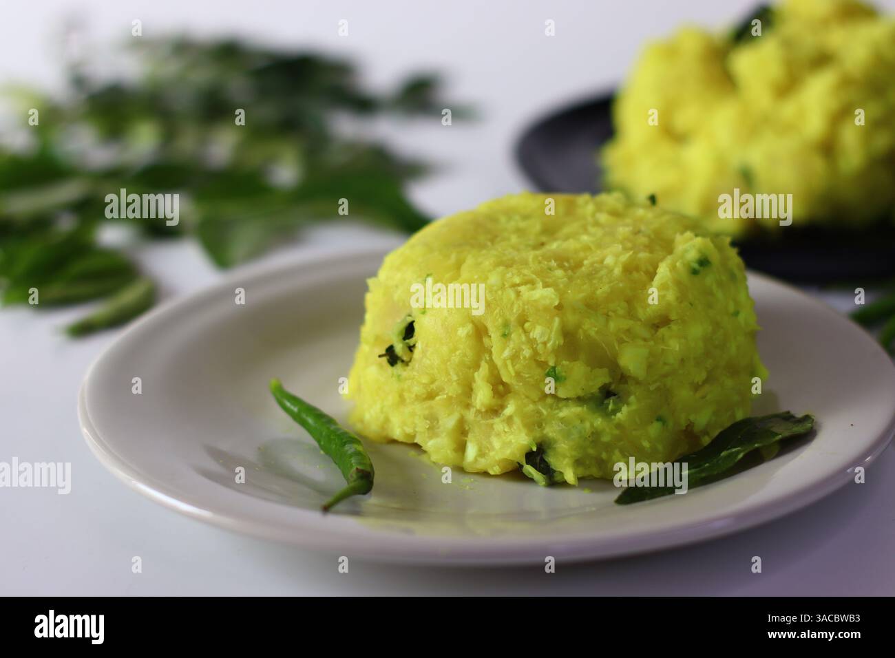 Boiled and mashed tapioca, blended with turmeric and garnished with ...