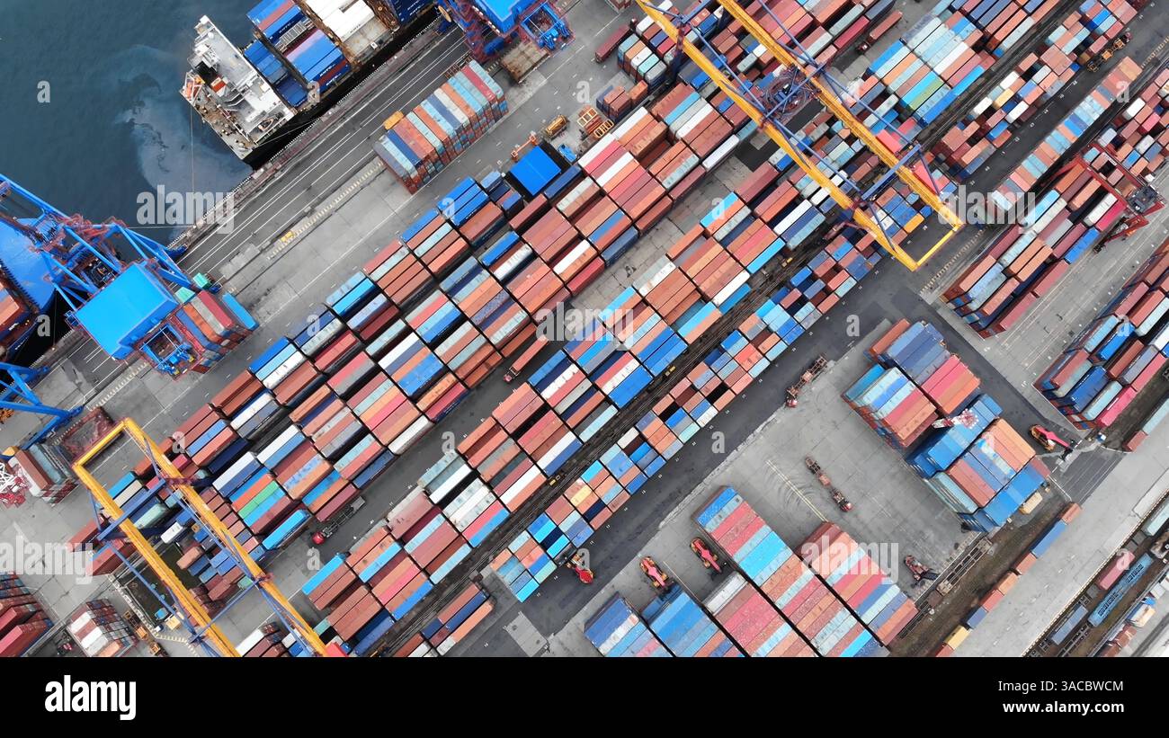Overhead view showing cargo container vessel navigating maritime shipping route, loading ...