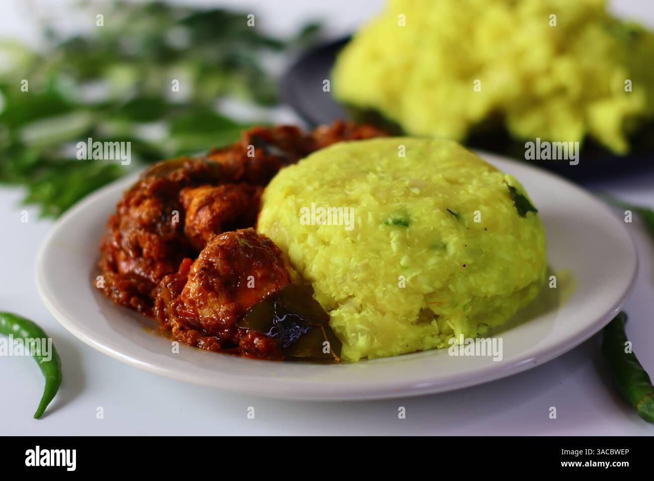 Boiled and mashed tapioca served with rich and spicy chicken curry ...