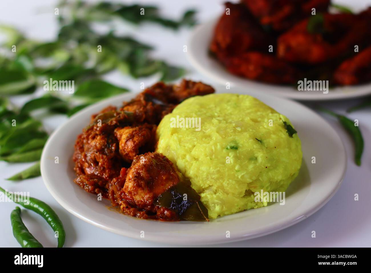 Boiled and mashed tapioca served with spicy chicken curry and crispy ...