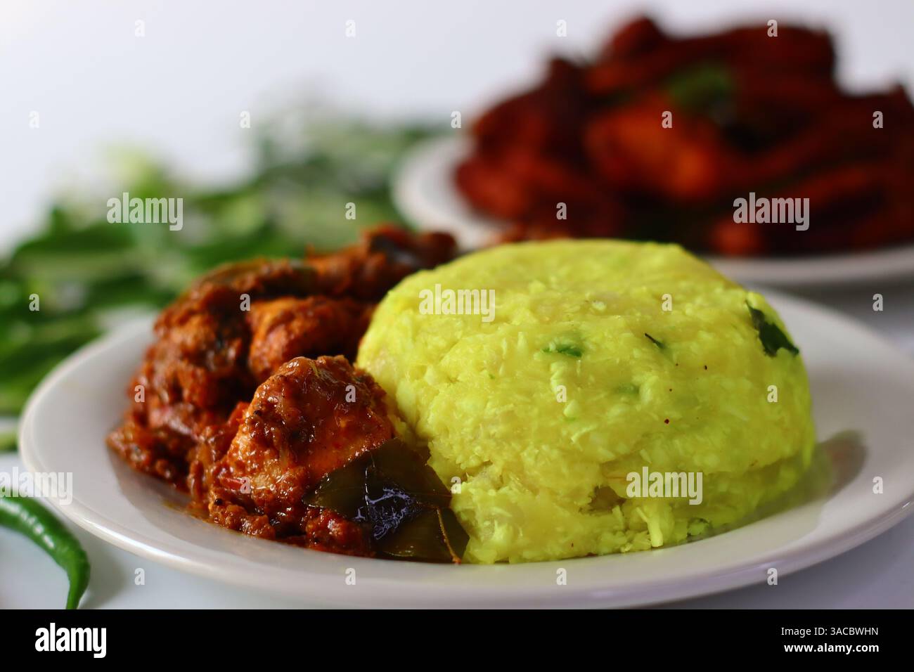 Boiled and mashed tapioca served with spicy chicken curry and crispy ...