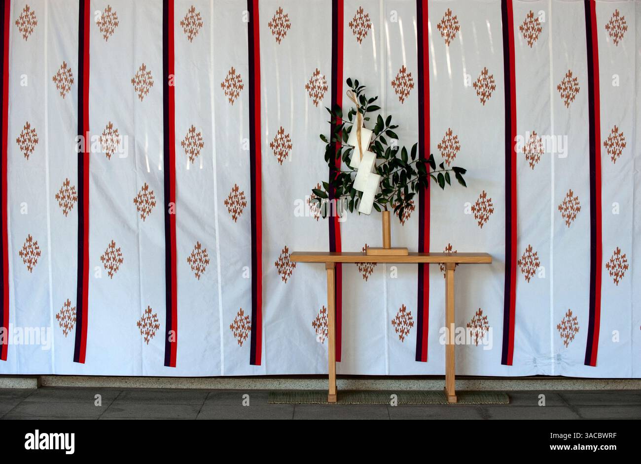 Sakaki evergreen branch with a zigzag folded white paper shide sits on ...