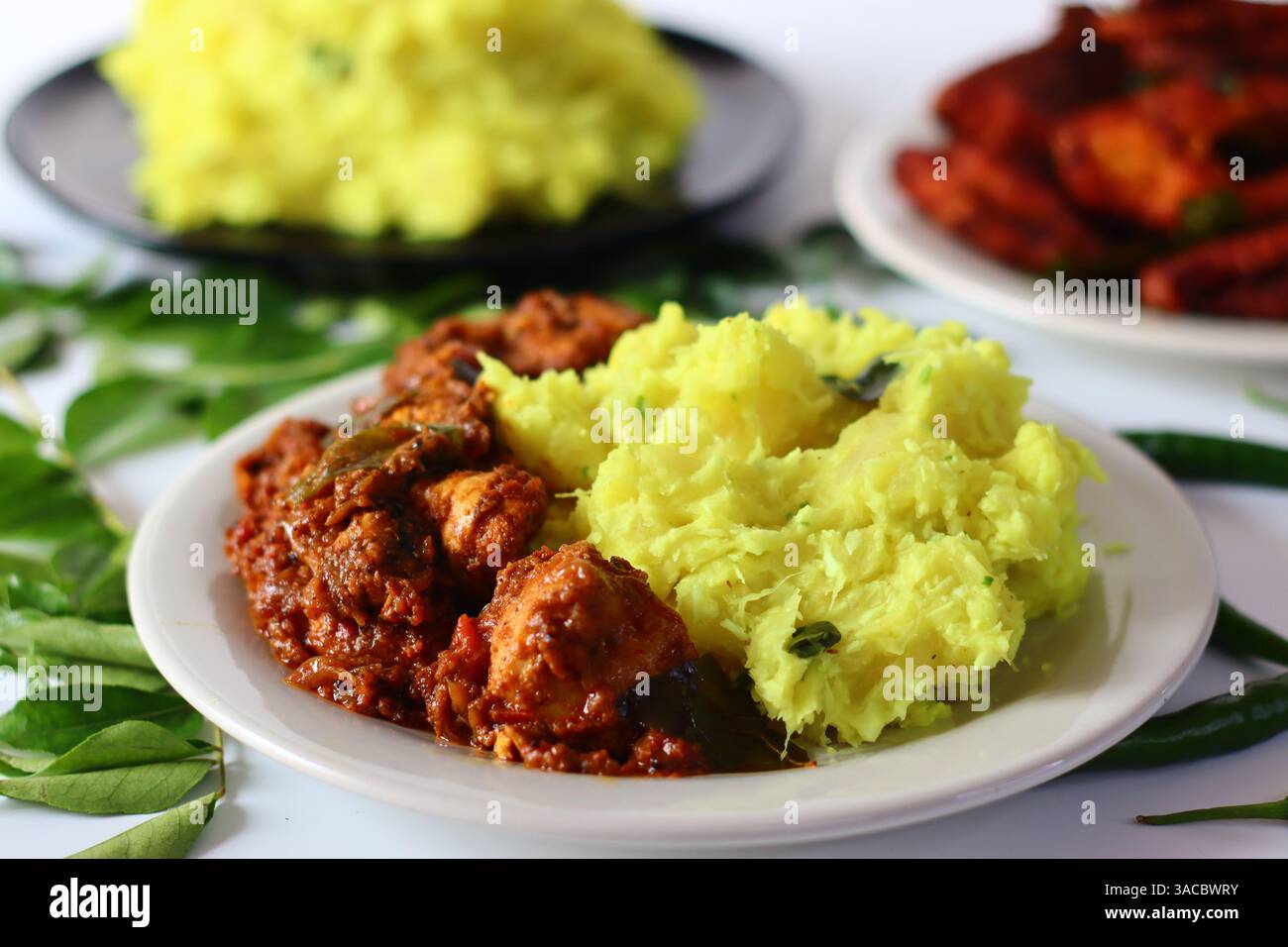 Boiled and mashed tapioca served with spicy chicken curry and crispy ...