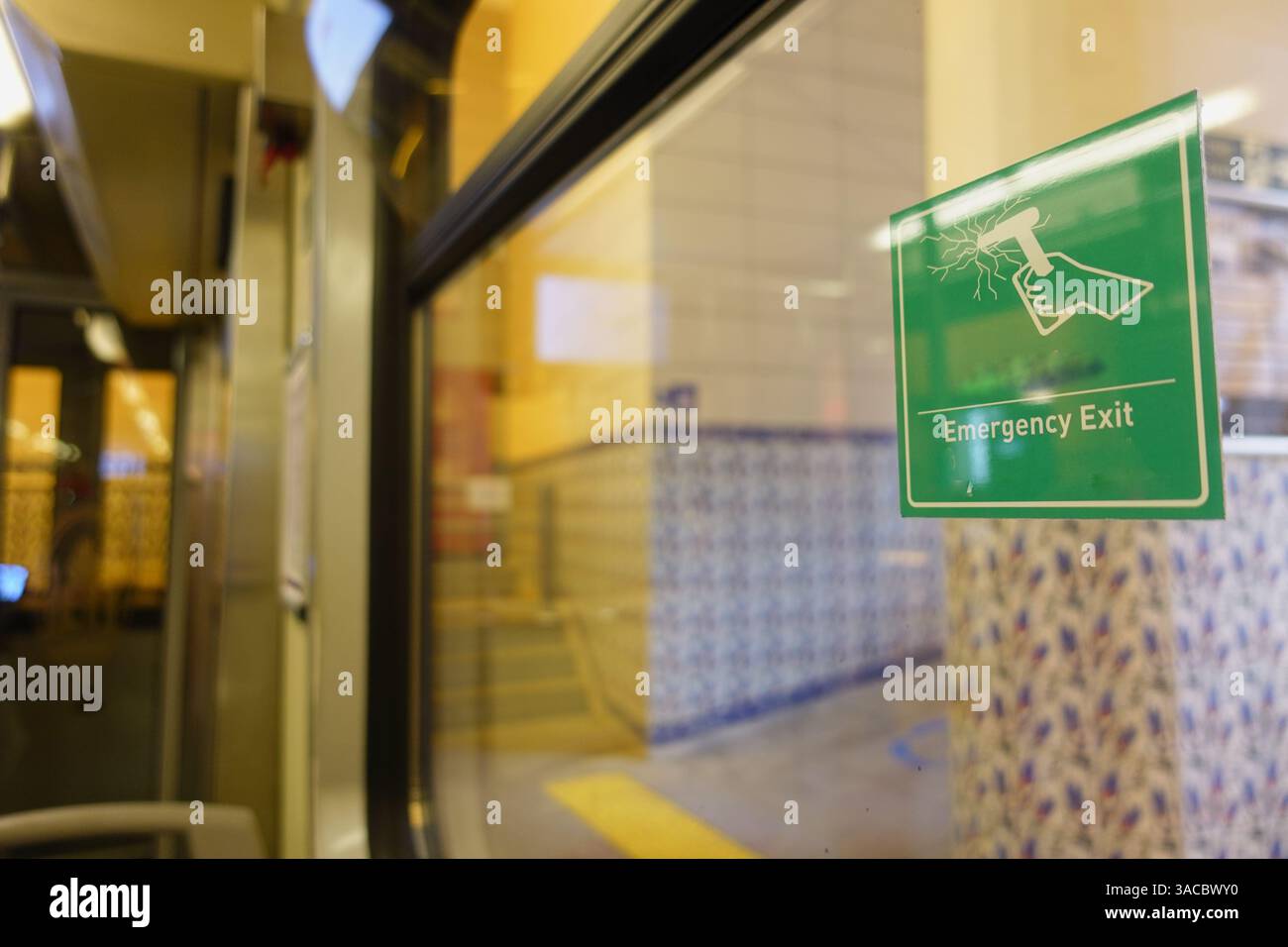 Emergency exit sign visible in public transport station interior Stock ...