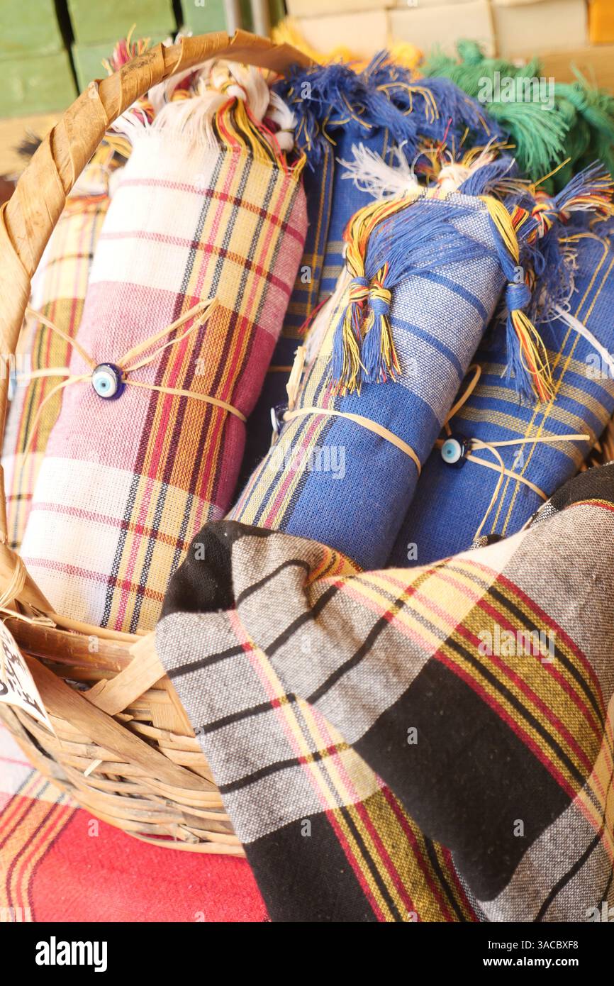 Colorful textiles displayed in a woven basket at a market Stock Photo ...