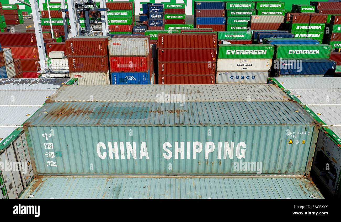 Cargo containers line a shipping terminal at the Port of Oakland on ...