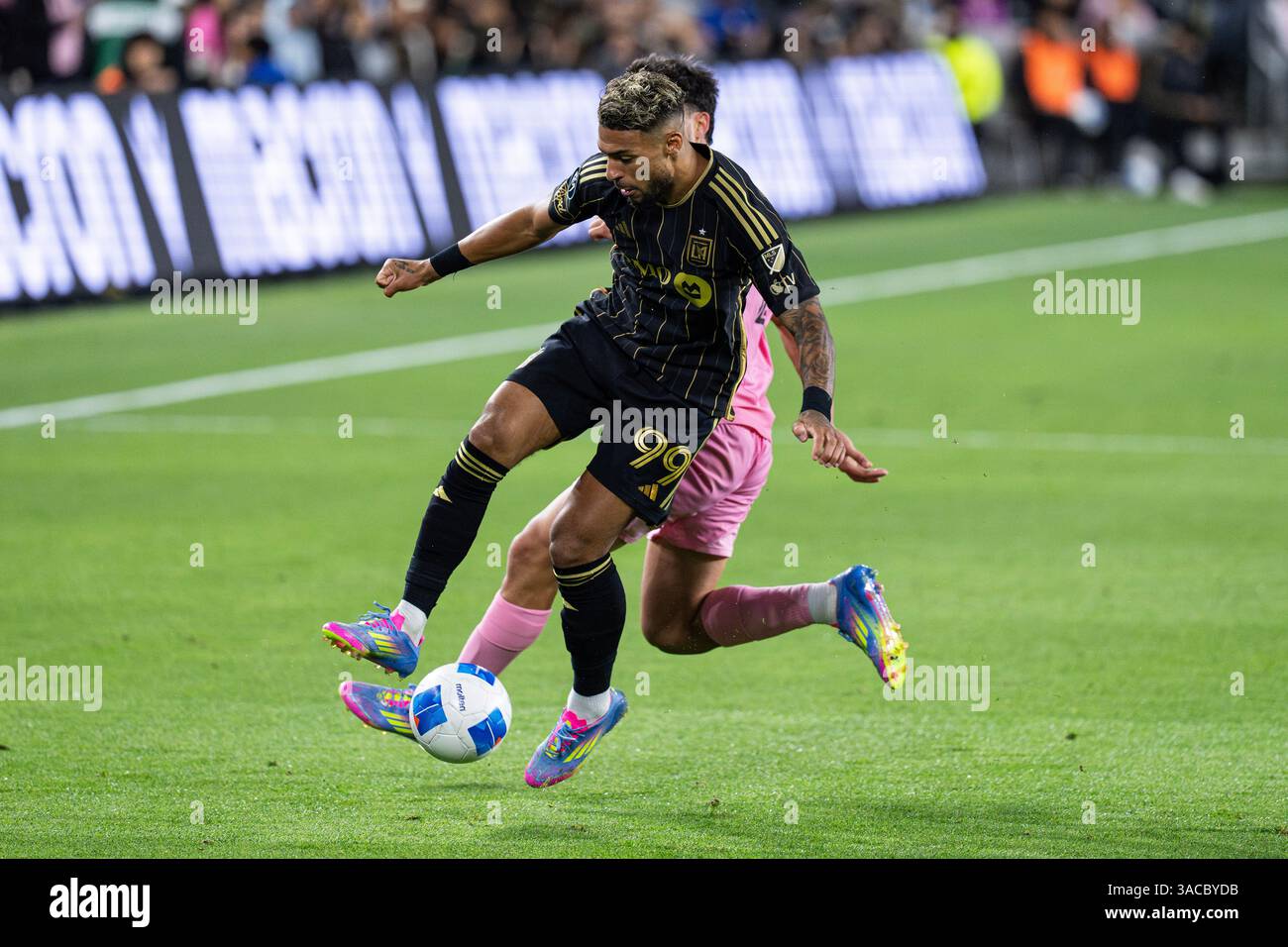 LAFC forward Denis Bouanga (99) gains possession against Inter Miami CF defender Gonzalo Luján ...