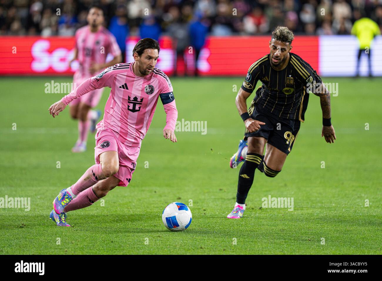 Inter Miami CF forward Lionel Messi (10) is defended by LAFC forward Denis Bouanga (99) during a ...