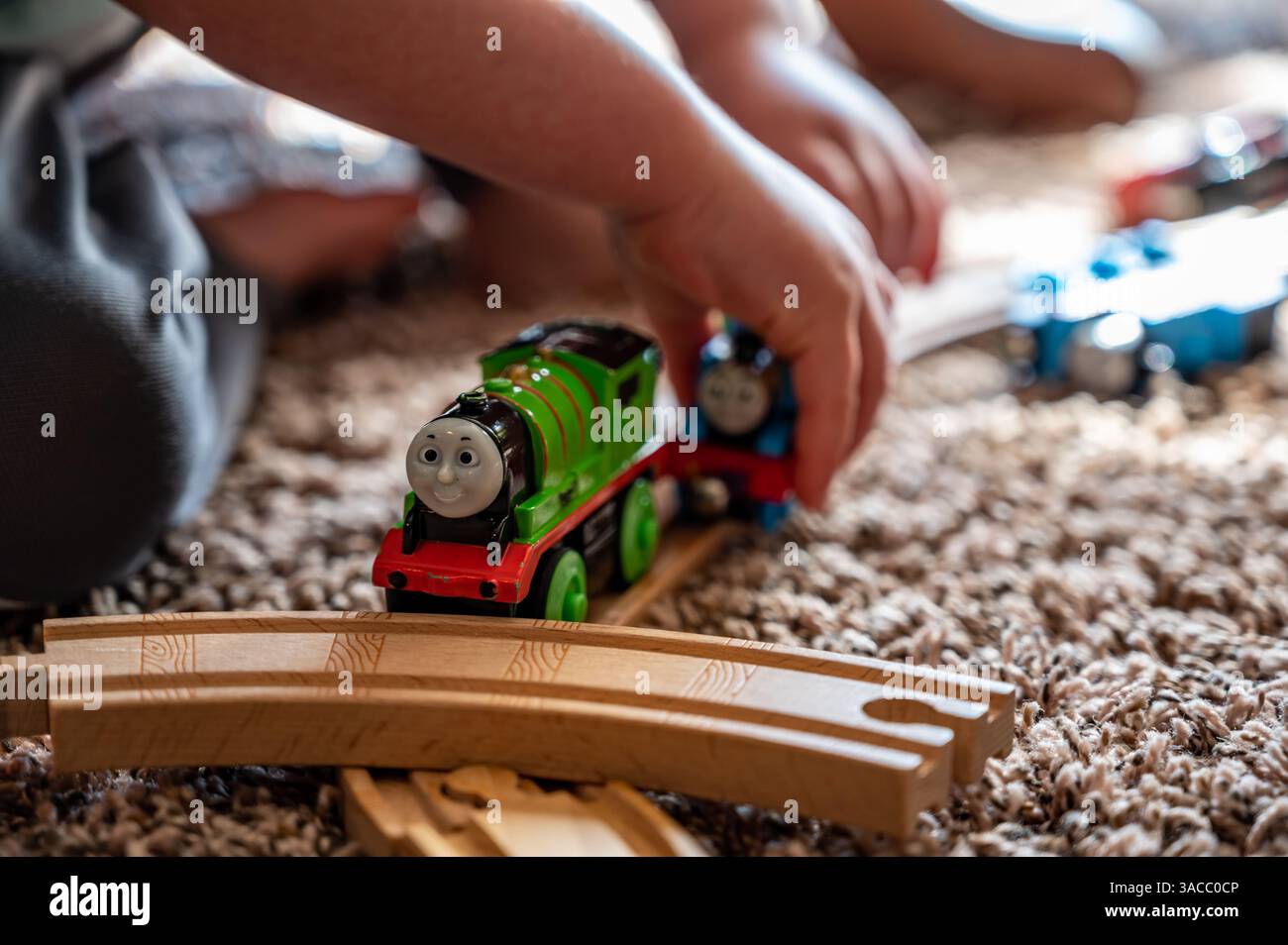 Tiffin, Iowa, USA - 3.2021: Small boy playing with a model Thomas the ...