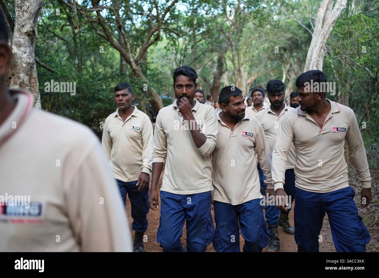 Vilvaraj Vinothan, second left, who works for the demining agency Mine Advisory Group, arrives ...