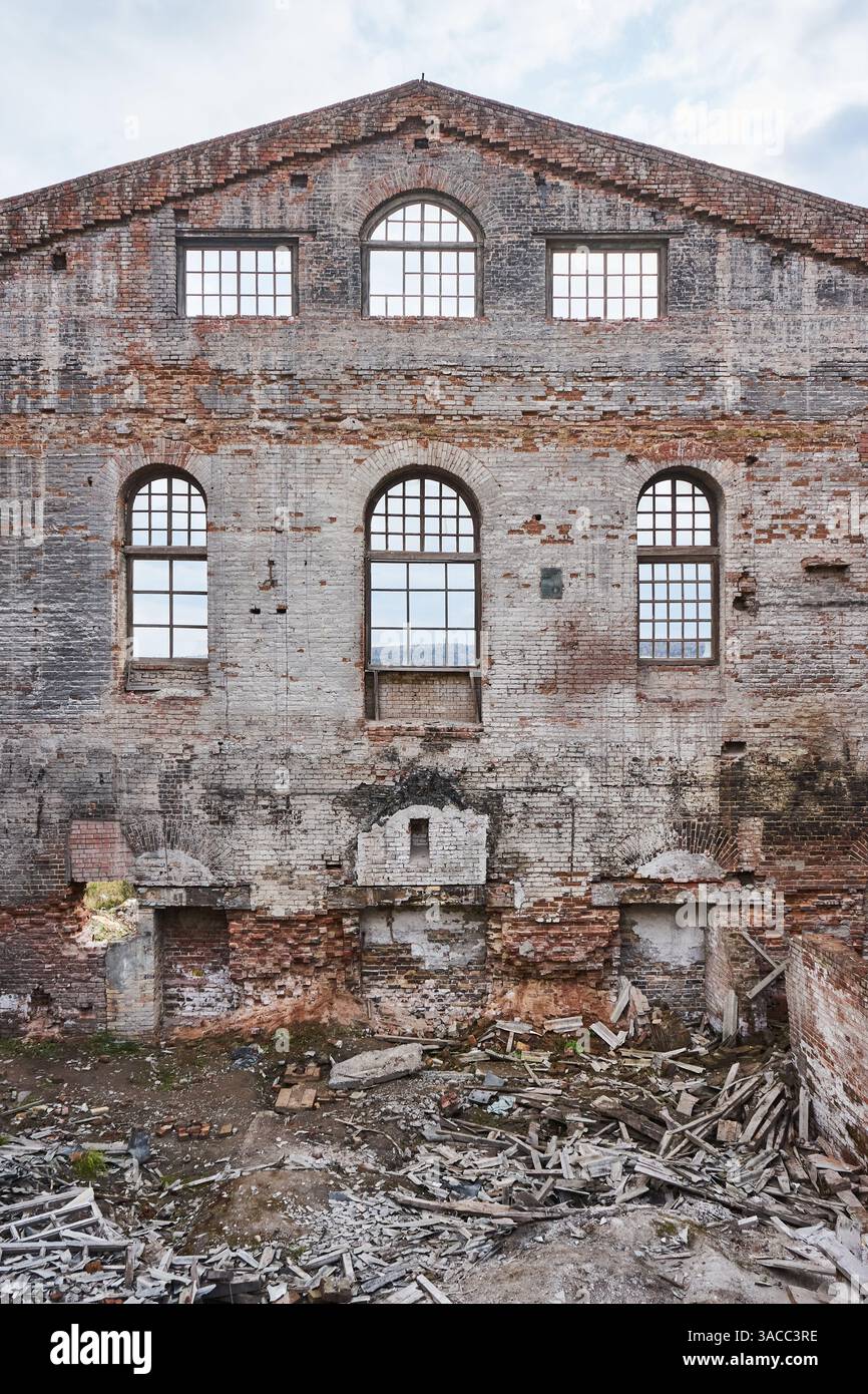 Abandoned destroyed brick building built in 1912. Wall with windows of ...