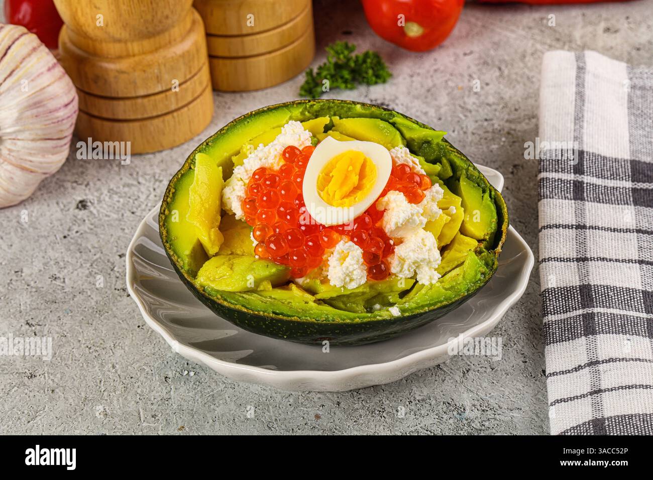 Avocado with red caviar and quil egg and soft cheese Stock Photo - Alamy