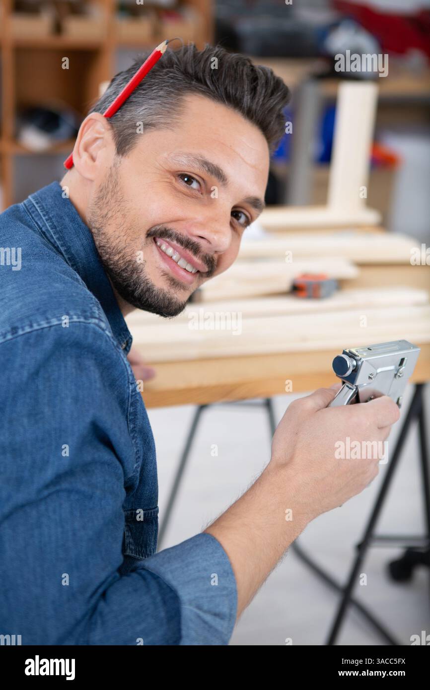 male carpenter using a staple gun Stock Photo - Alamy