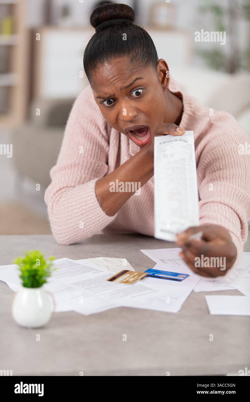 woman in shock looking at a receipt Stock Photo - Alamy