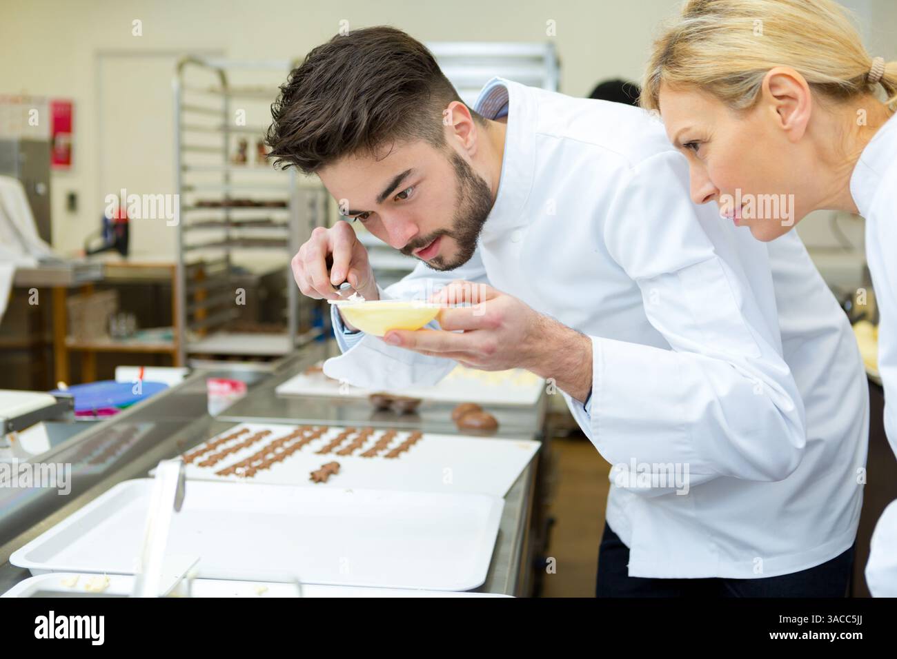 portrait of workers making chocolate Stock Photo - Alamy