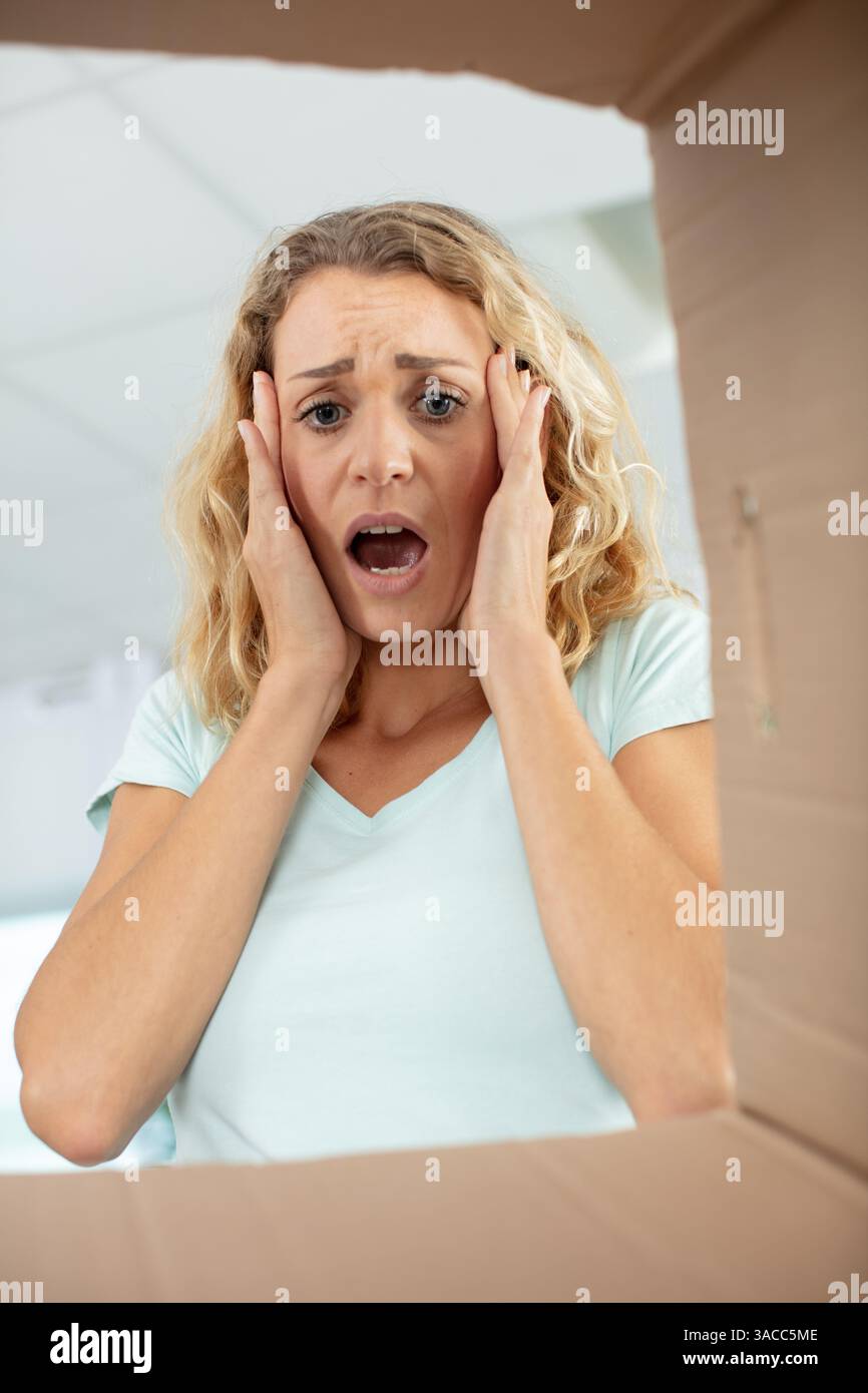 disappointed woman receive damaged wrong parcel Stock Photo - Alamy