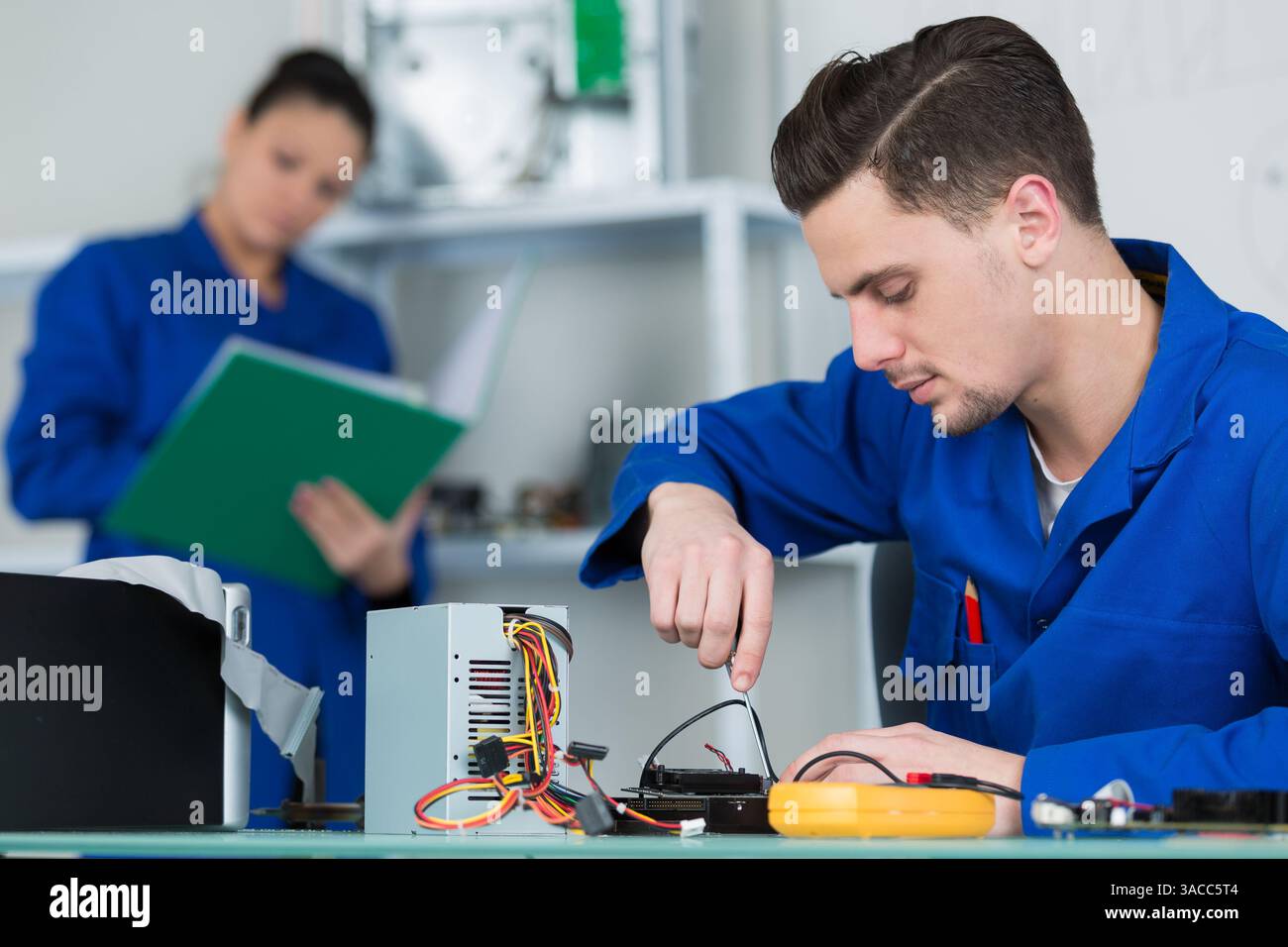 team of students examining and repairing computer parts Stock Photo - Alamy