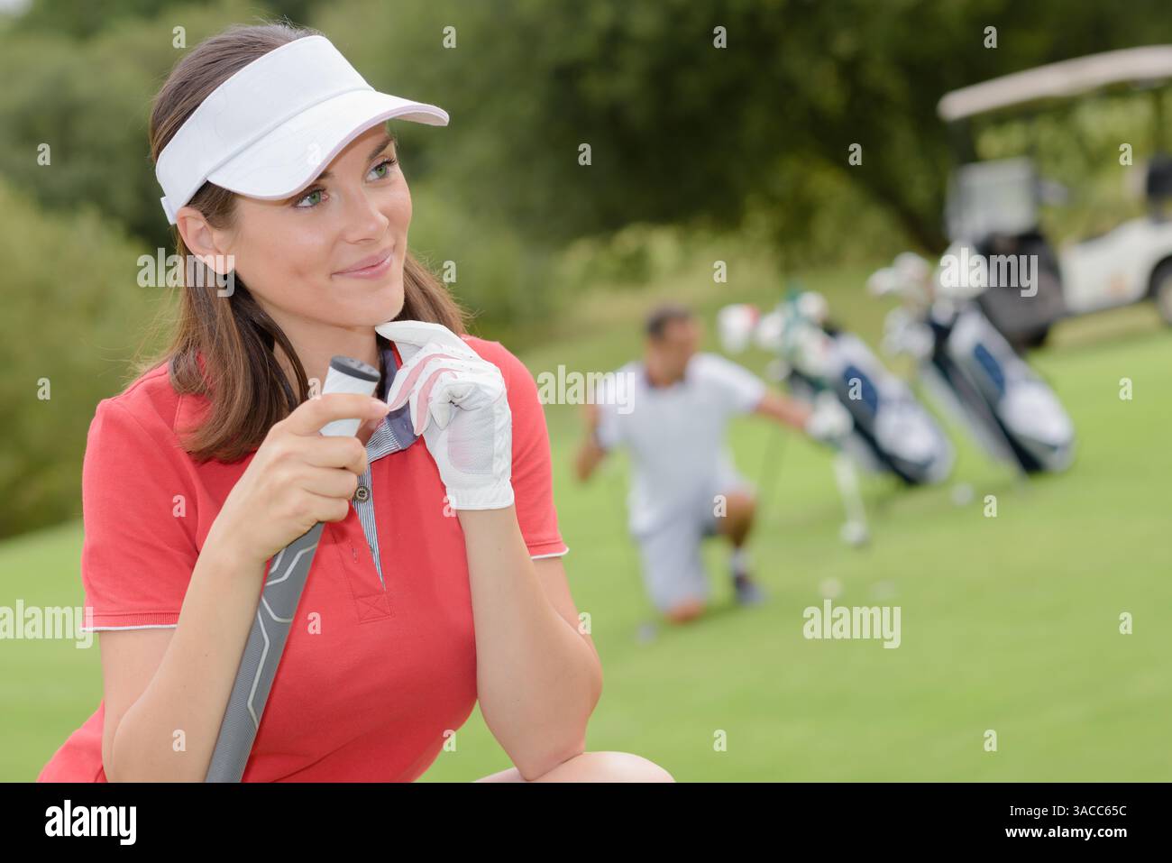 closeup portrait of attractive female golfer on the fields smiling ...