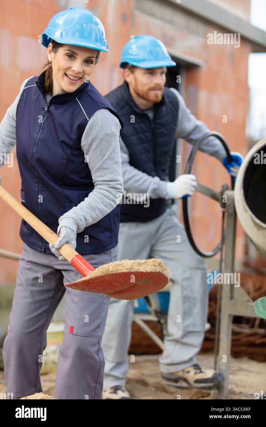 builders workes with concrete mixer Stock Photo - Alamy