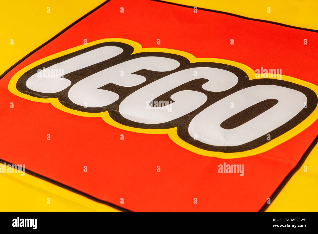 Bright yellow background with a large, colorful Lego logo prominently ...