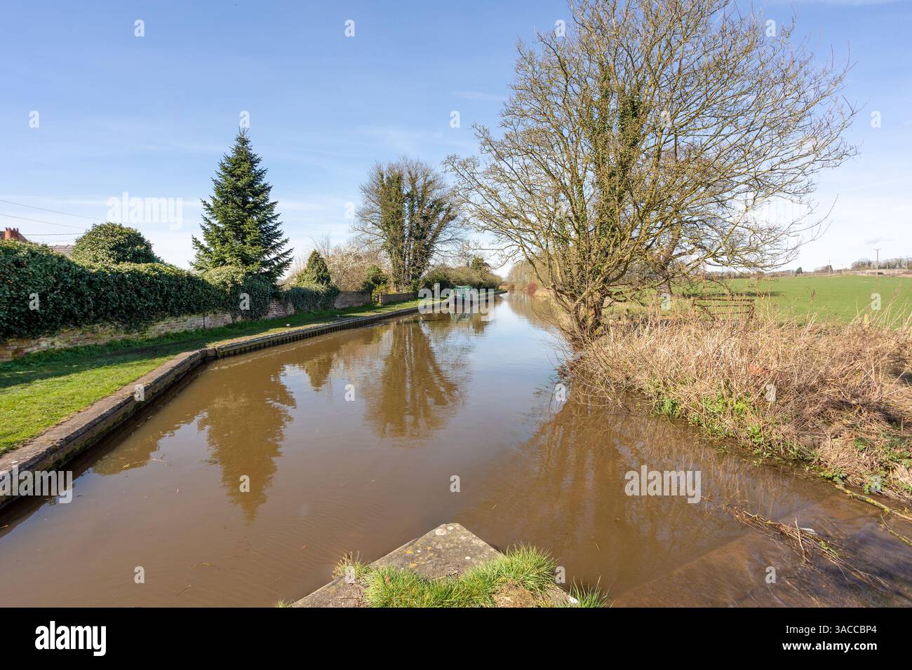 a peaceful tranquil canal scene. Looking down the canal from a place ...