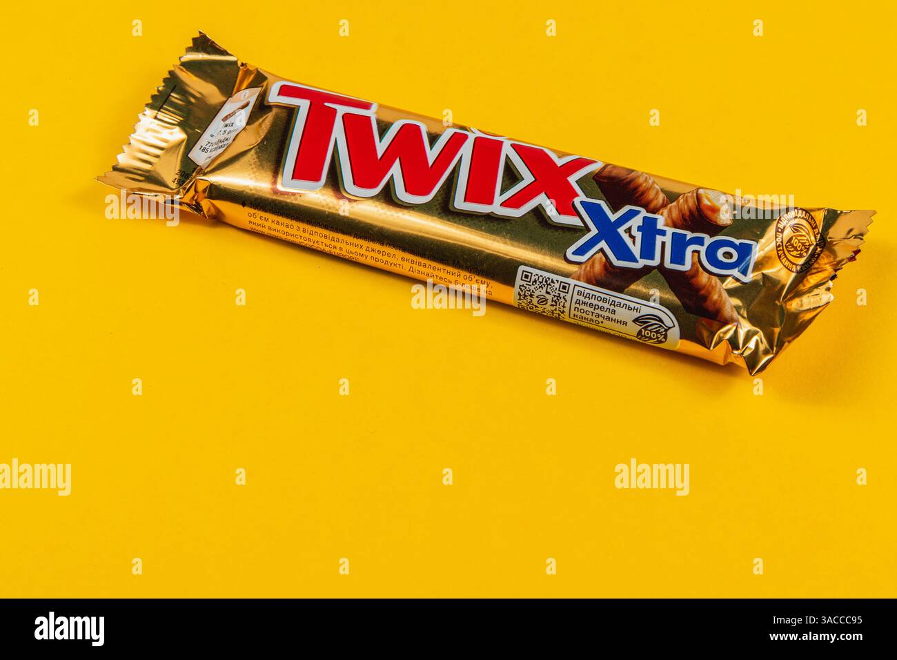 Lviv Ukraine 04.02.25 A Twix Xtra candy bar lies on a vibrant yellow ...
