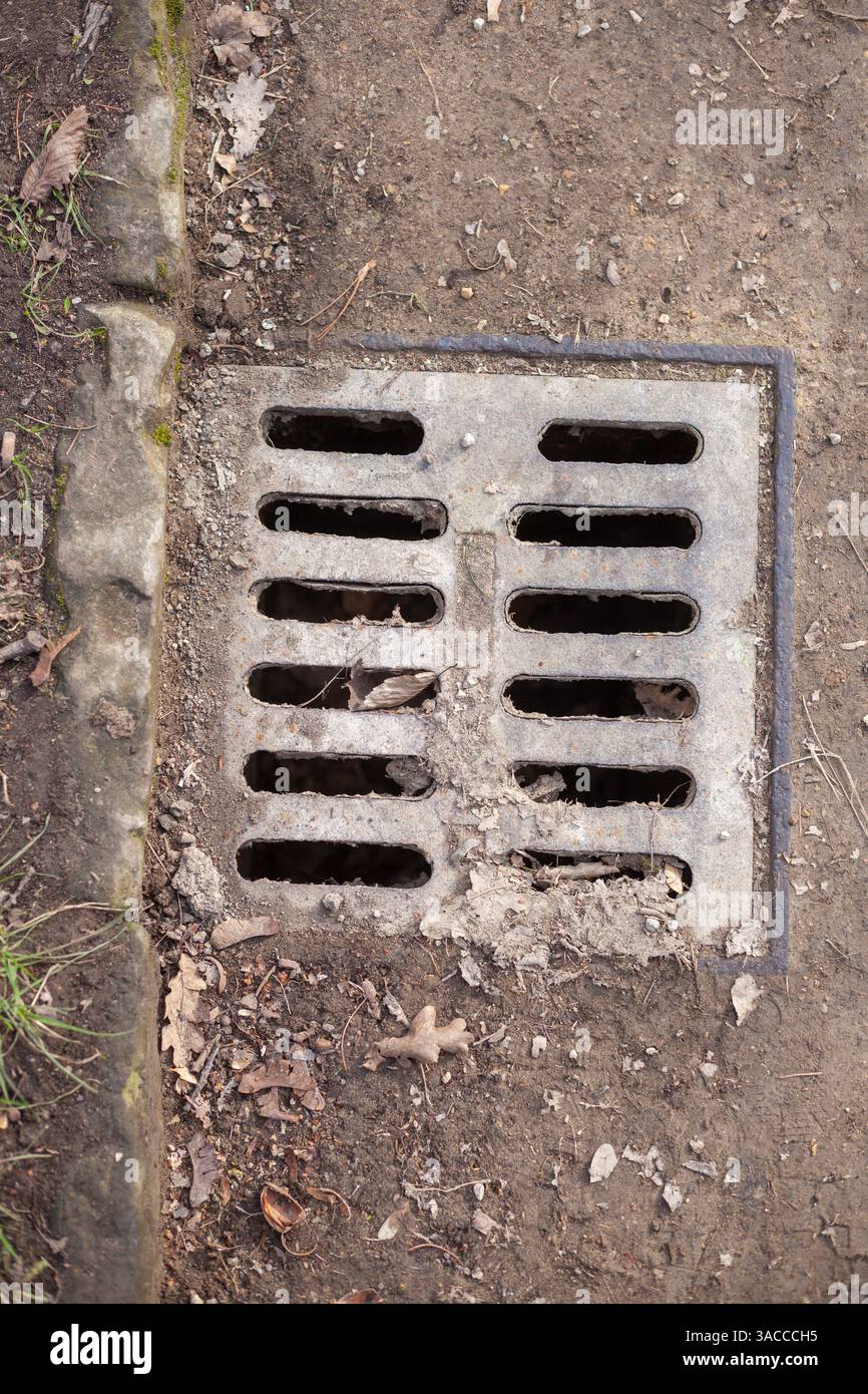 Old muddy manhole cover with curb, top view, Germany Stock Photo - Alamy