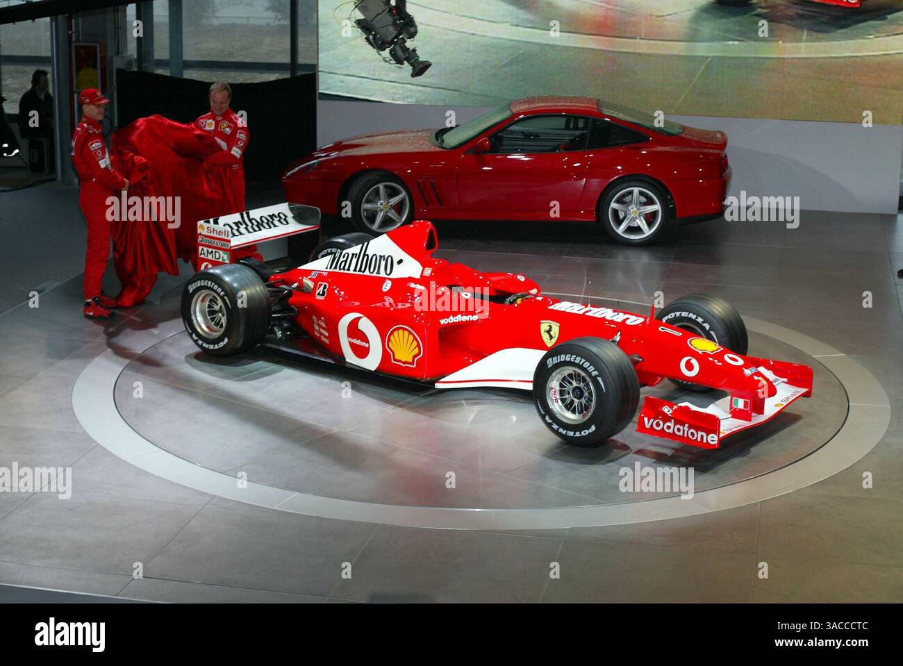 The new Ferrari F2002 is unveiled by Michael Schumacher (GER), left ...
