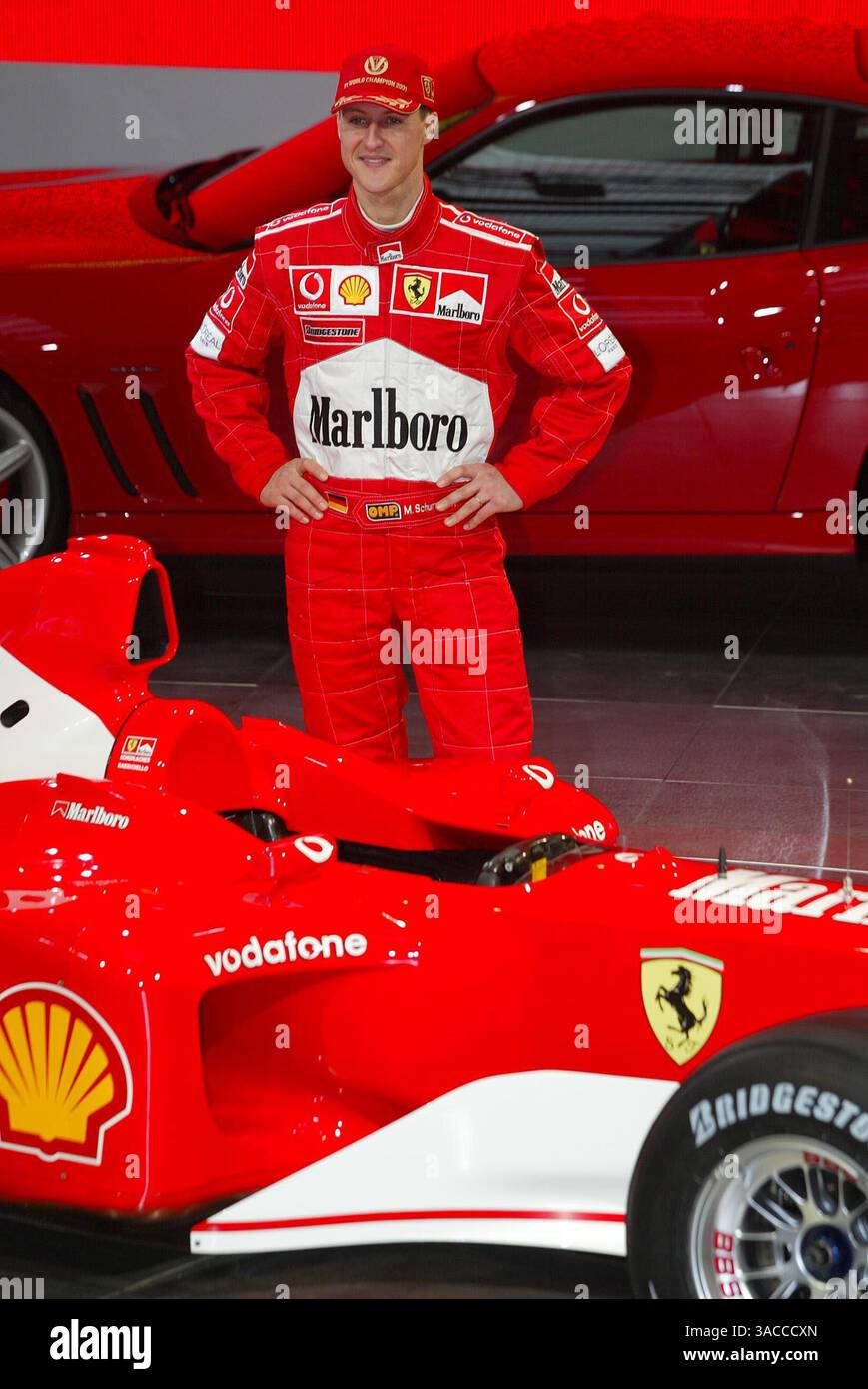 2001 F1 World Champion Michael Schumacher (GER) stands alongside the ...