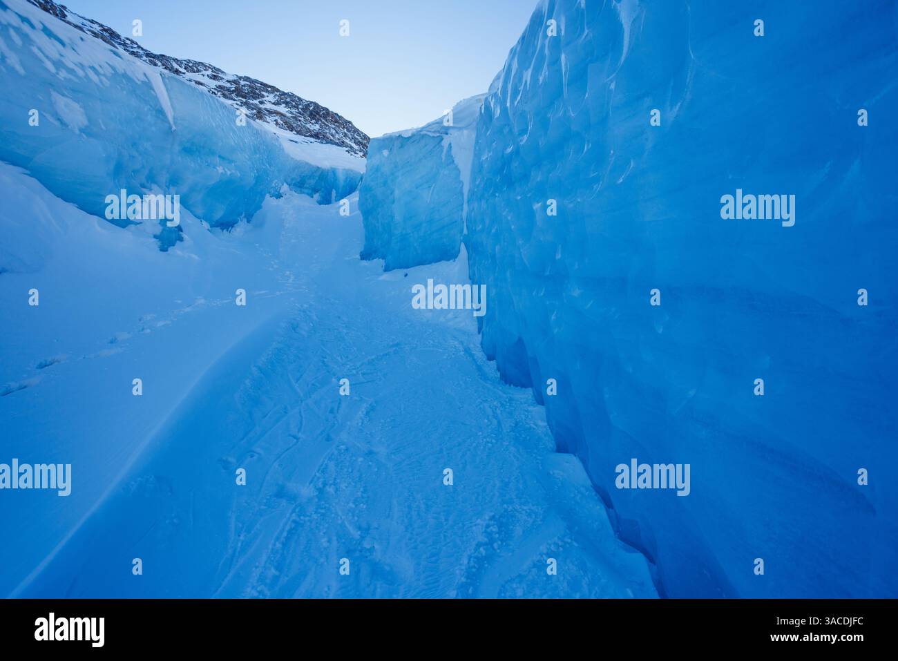 Stunning blue ice canyon with rugged, snowy walls in mountains Stock ...
