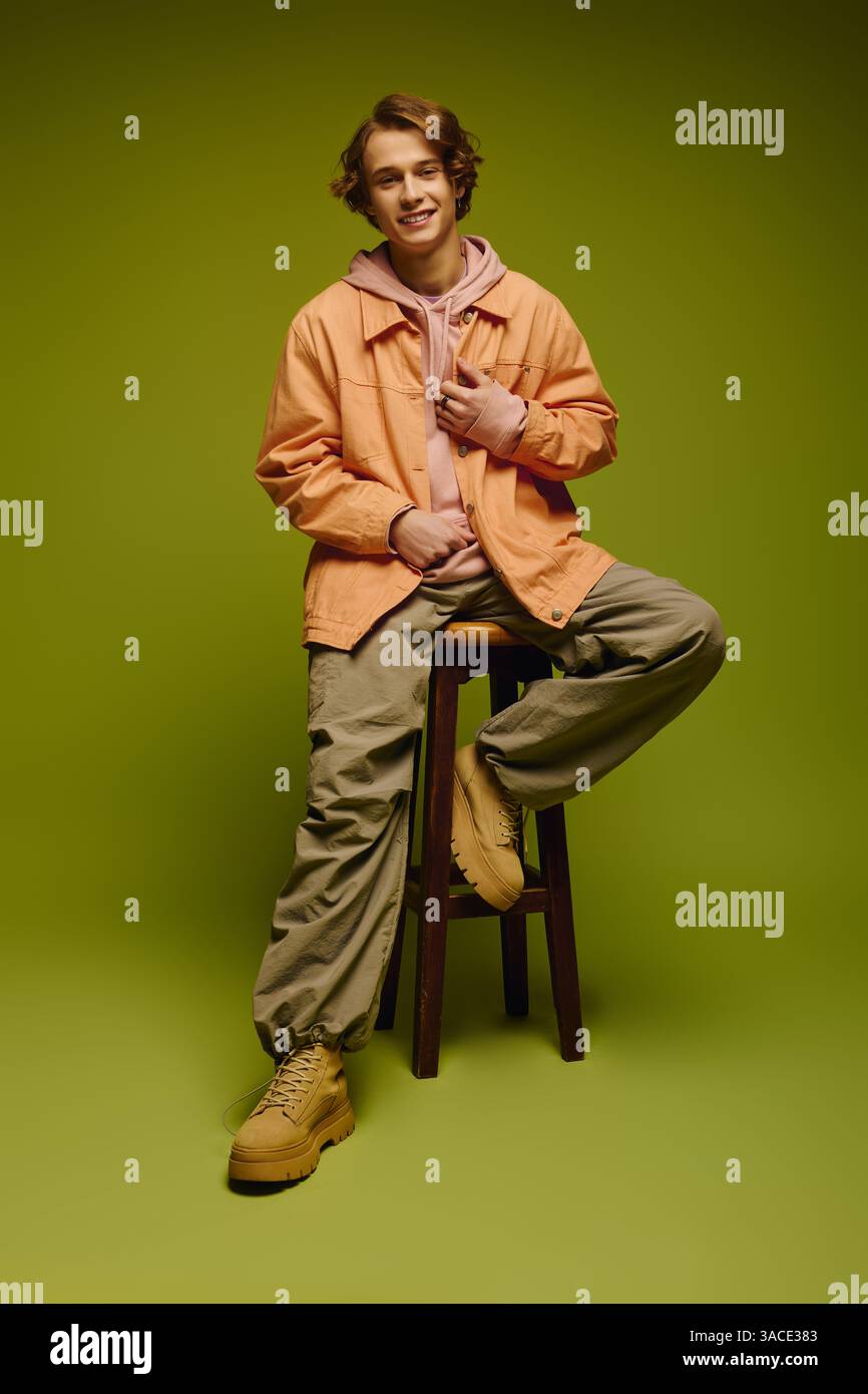 Charming young man poses confidently in modern attire, radiating youth ...