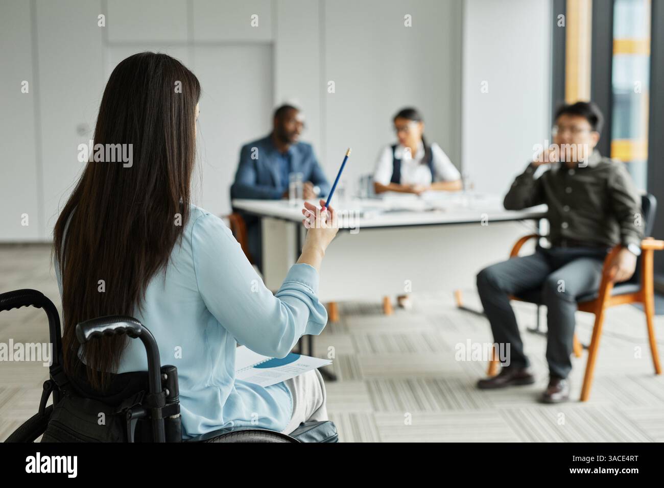 Back view portrait of young woman in wheelchair giving speech while ...