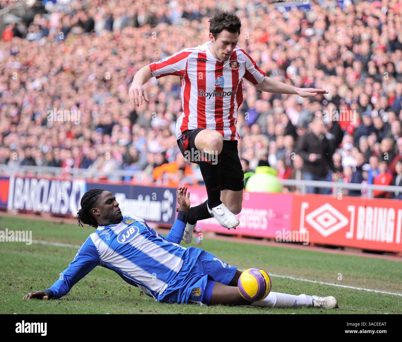 Sunderland's Daryl Murphy and Wigan's Mario Melchiot.(Credit Image ...
