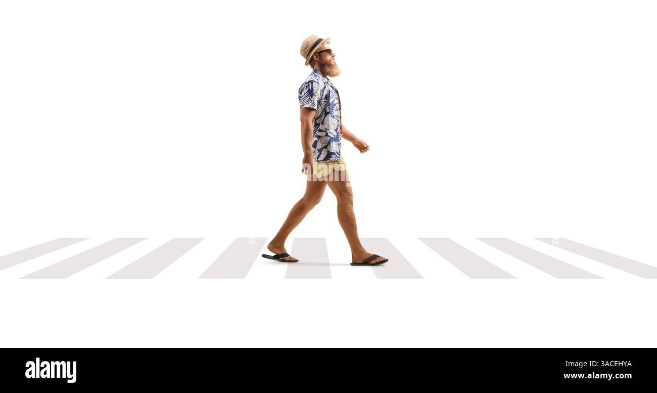 Full length profile shot of a male tourist with sunglasses crossing a ...