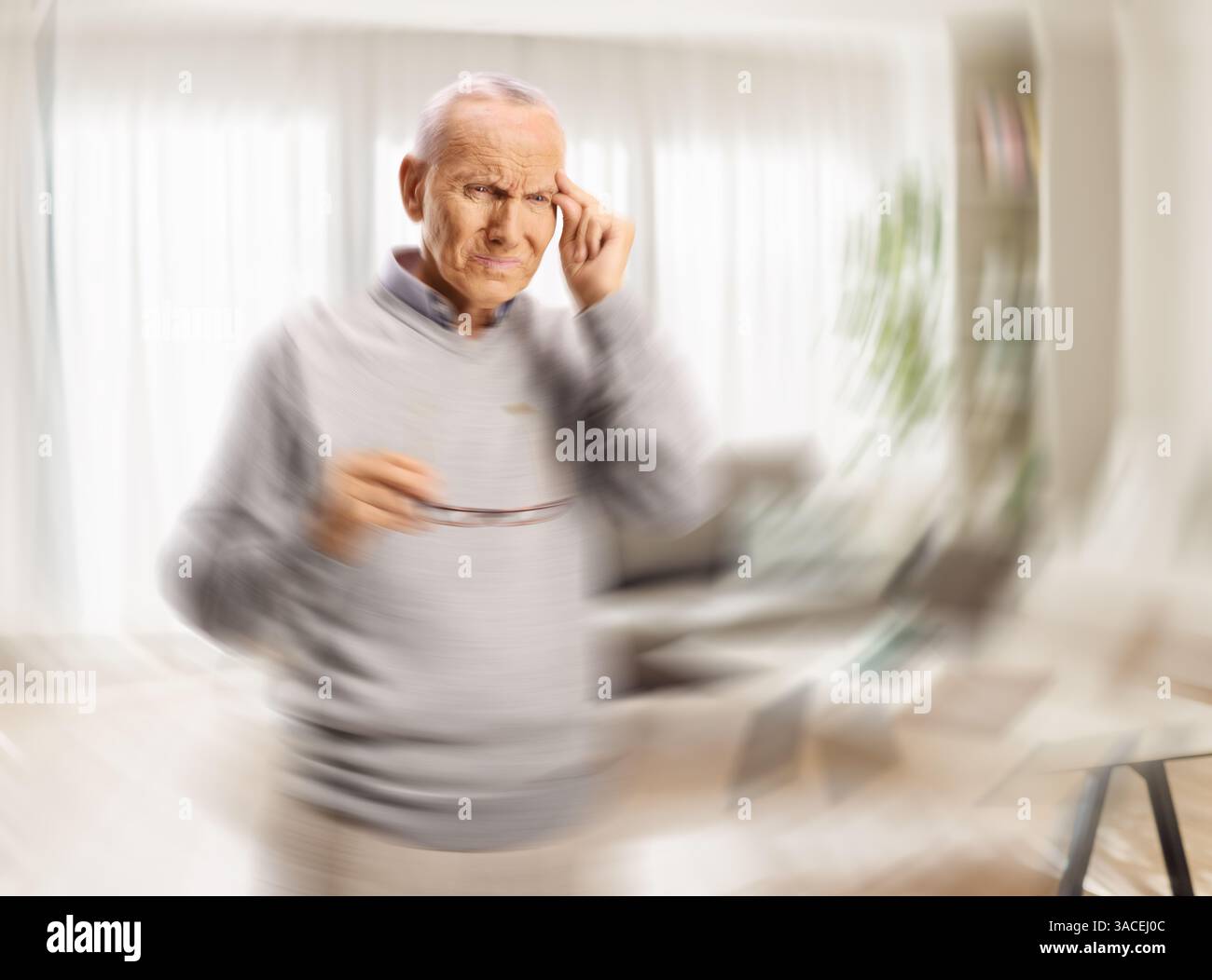 Elderly man with headache and dizziness standing in a living room Stock ...