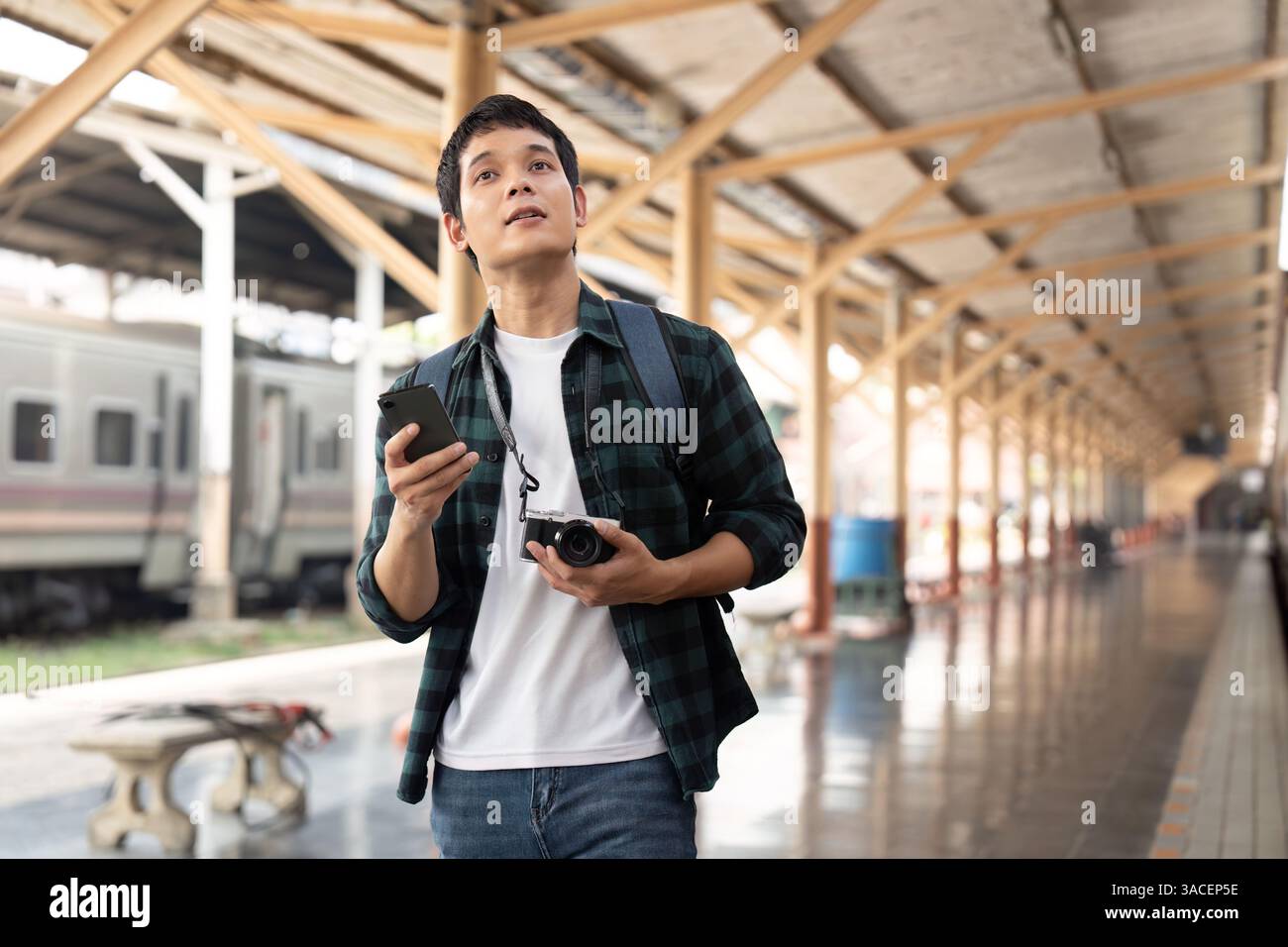 Exploration and Adventure. A traveler looks up at the train station ...