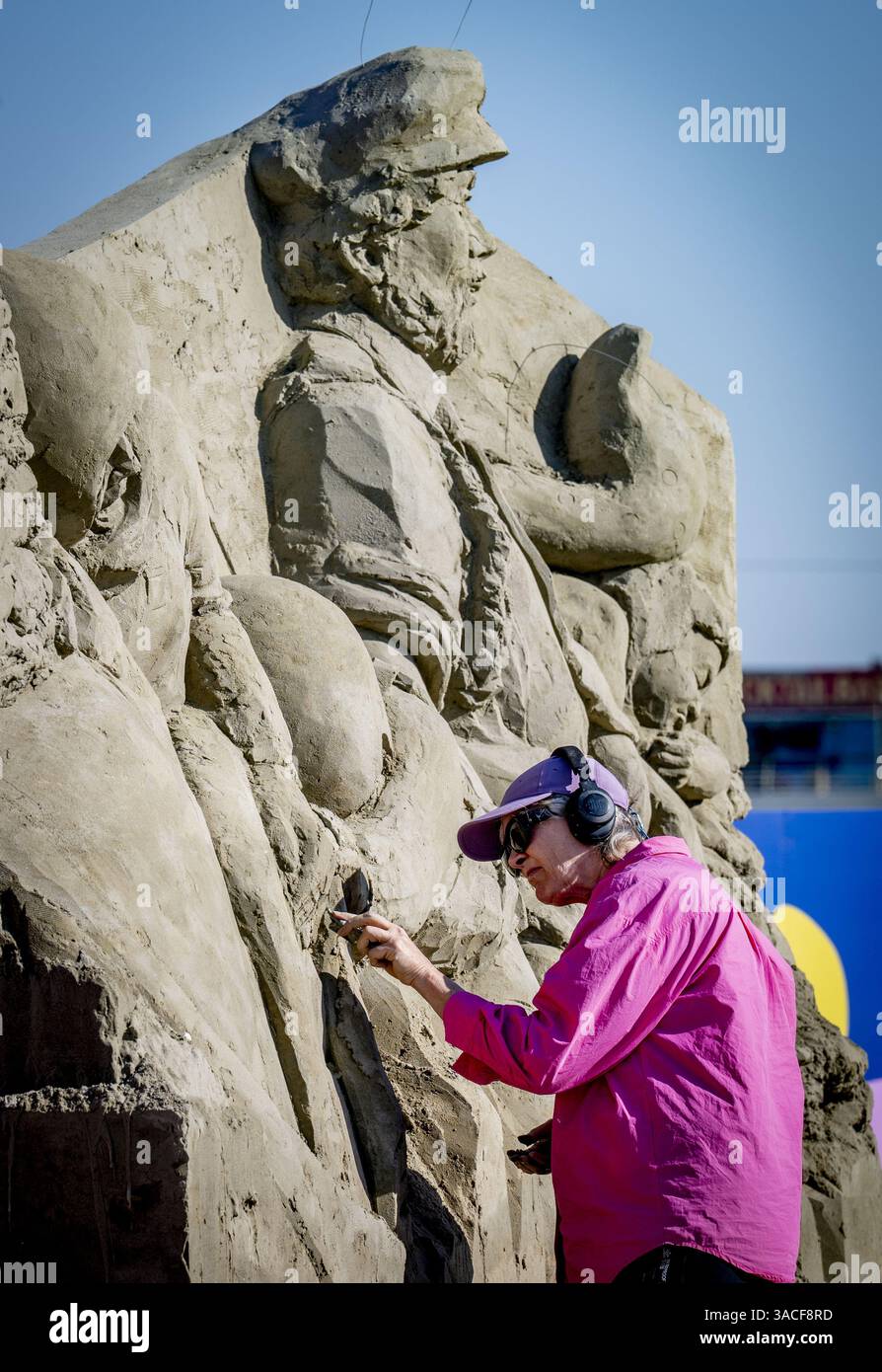 DEN HAAG - A maker works on a sand sculpture on Scheveningen's ...