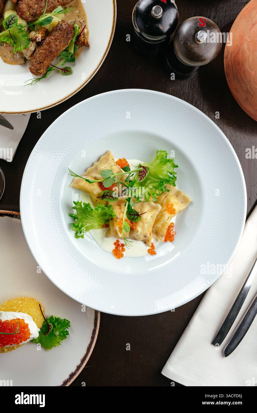 ravioli with sauce, herbs and caviar in a restaurant Stock Photo - Alamy