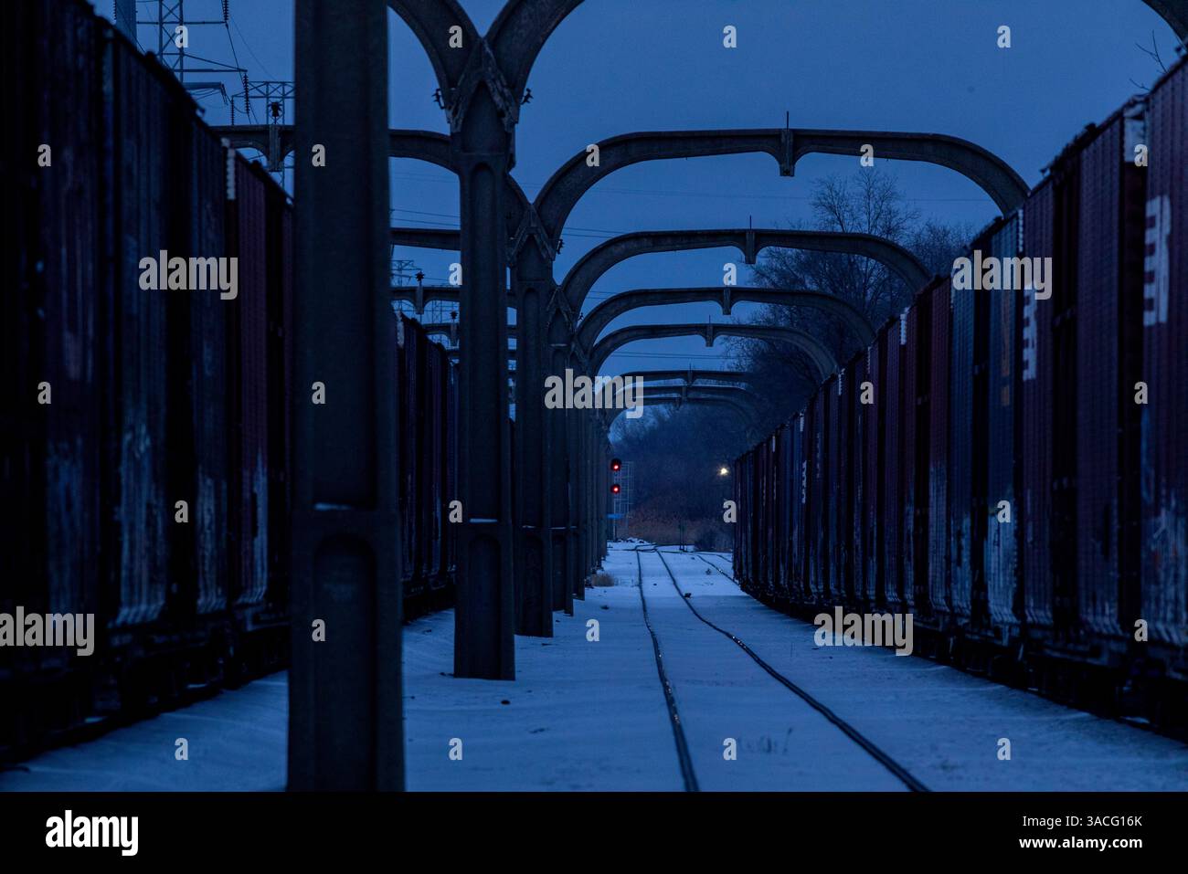 Historic catenary arches over train tracks at dusk Stock Photo - Alamy